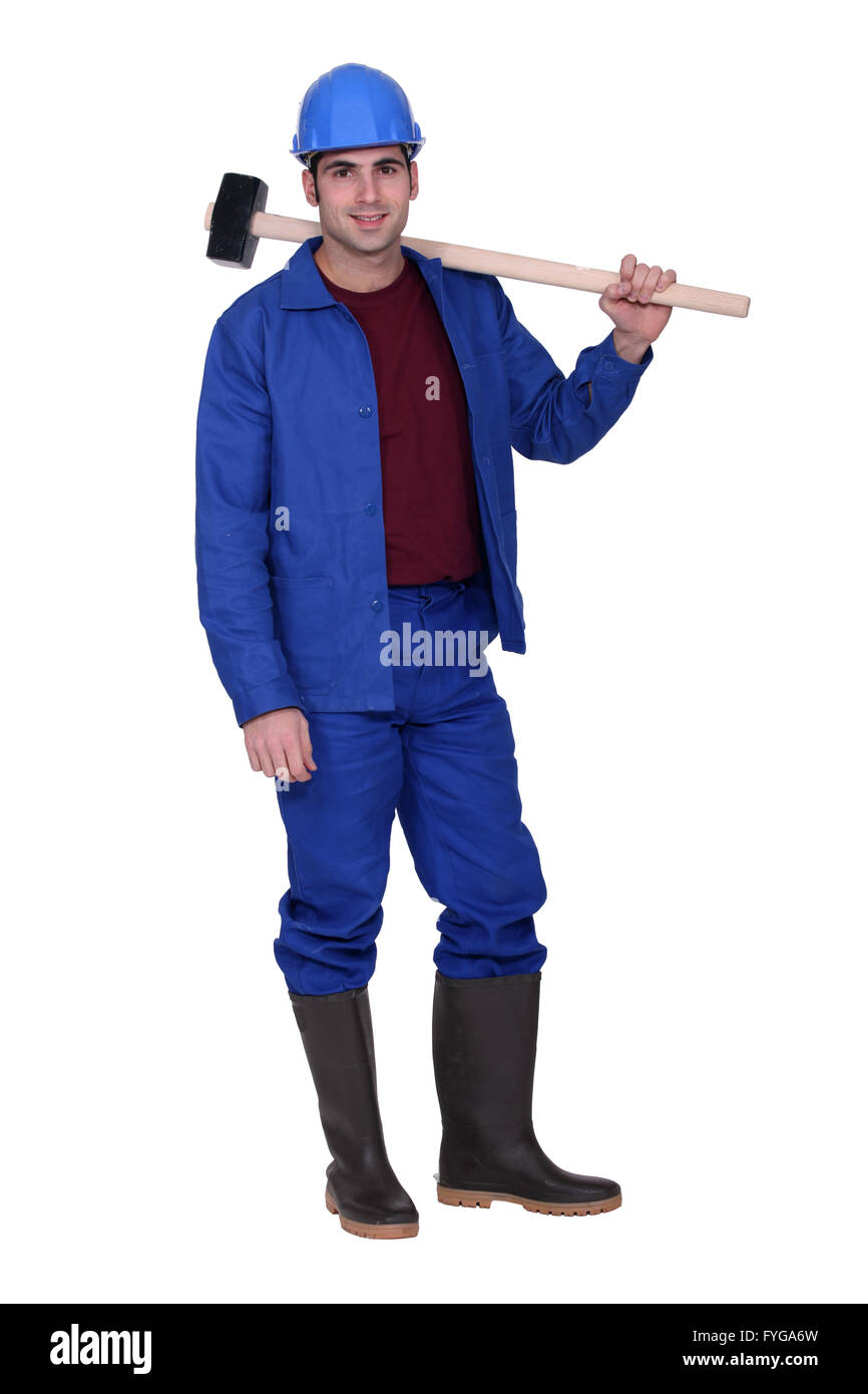 Man casually stood with sledge-hammer resting on shoulder Stock Photo ...