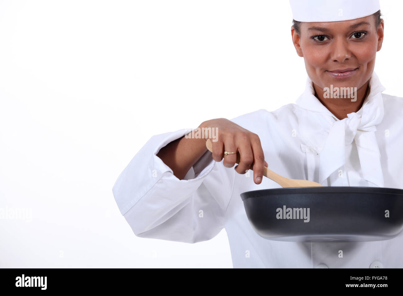 female cook with a high-sided frying pan and a wooden spoon Stock Photo ...