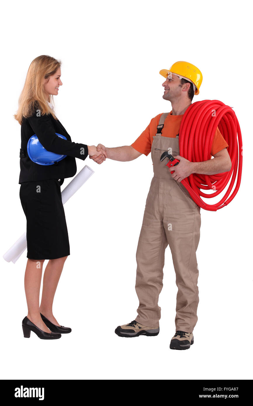 Business professional shaking a tradesman's hand Stock Photo - Alamy