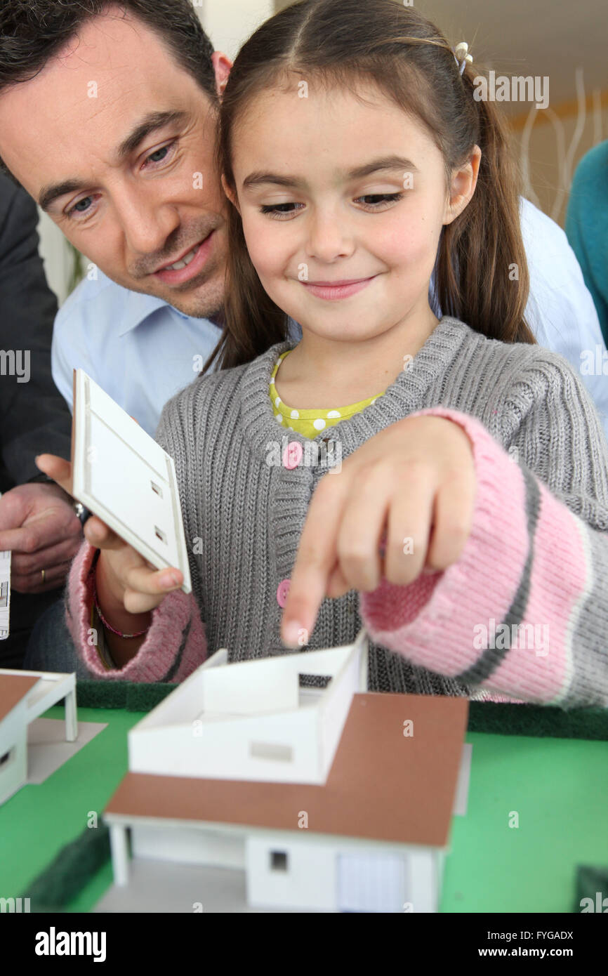 Little girl playing with scale model of housing Stock Photo - Alamy
