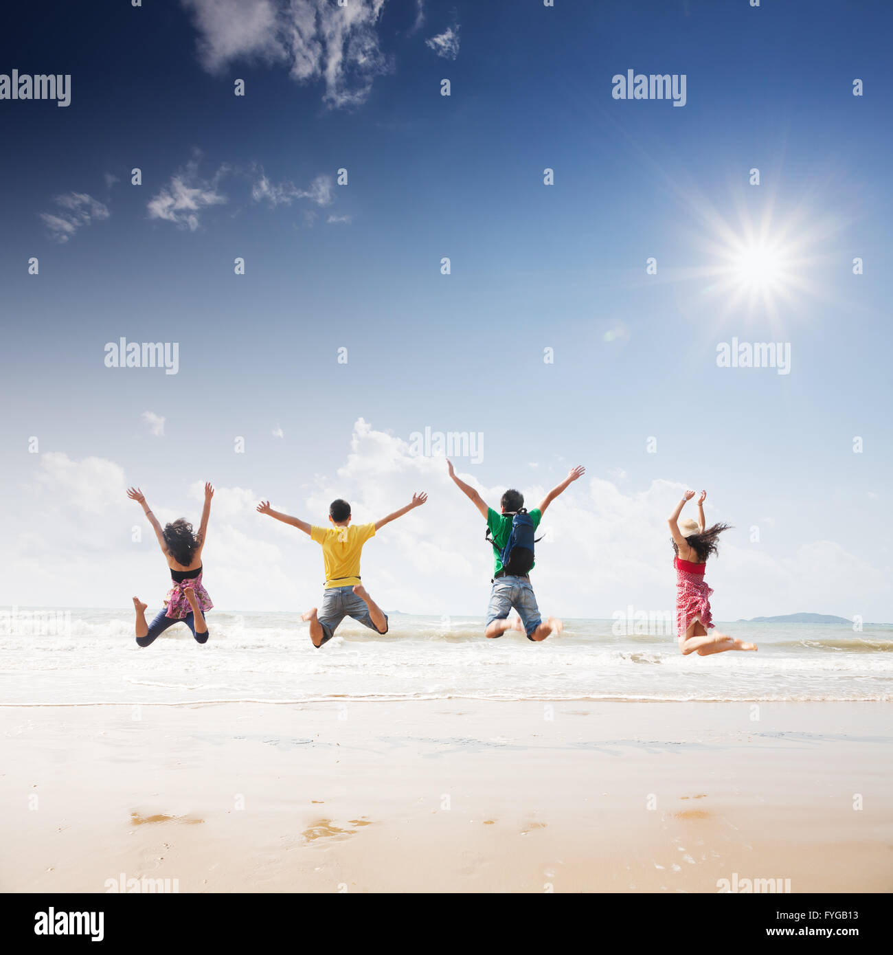 friends jumping on beach Stock Photo - Alamy
