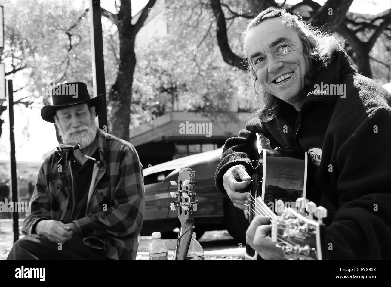 Two homeless men busking in Austin, TX Stock Photo - Alamy