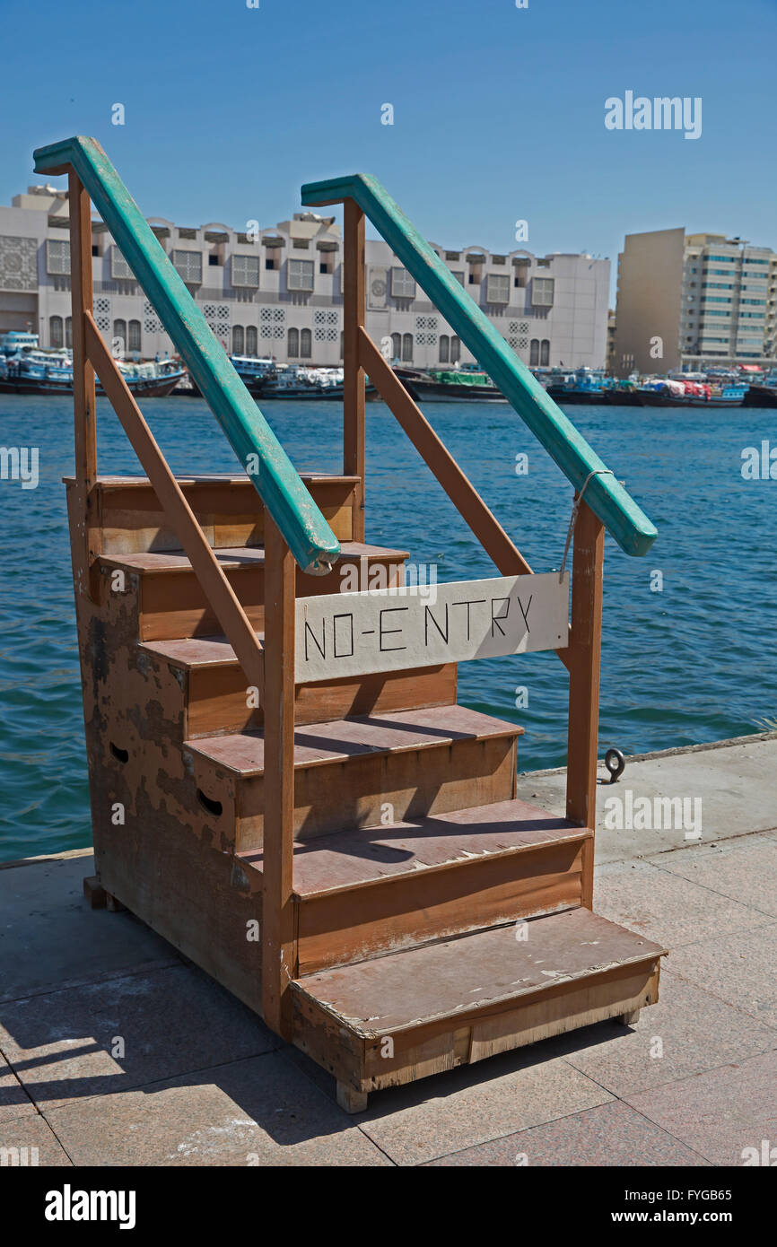 Wooden steps with a No Entry sign by the creek edge in Dubai UAE Stock ...
