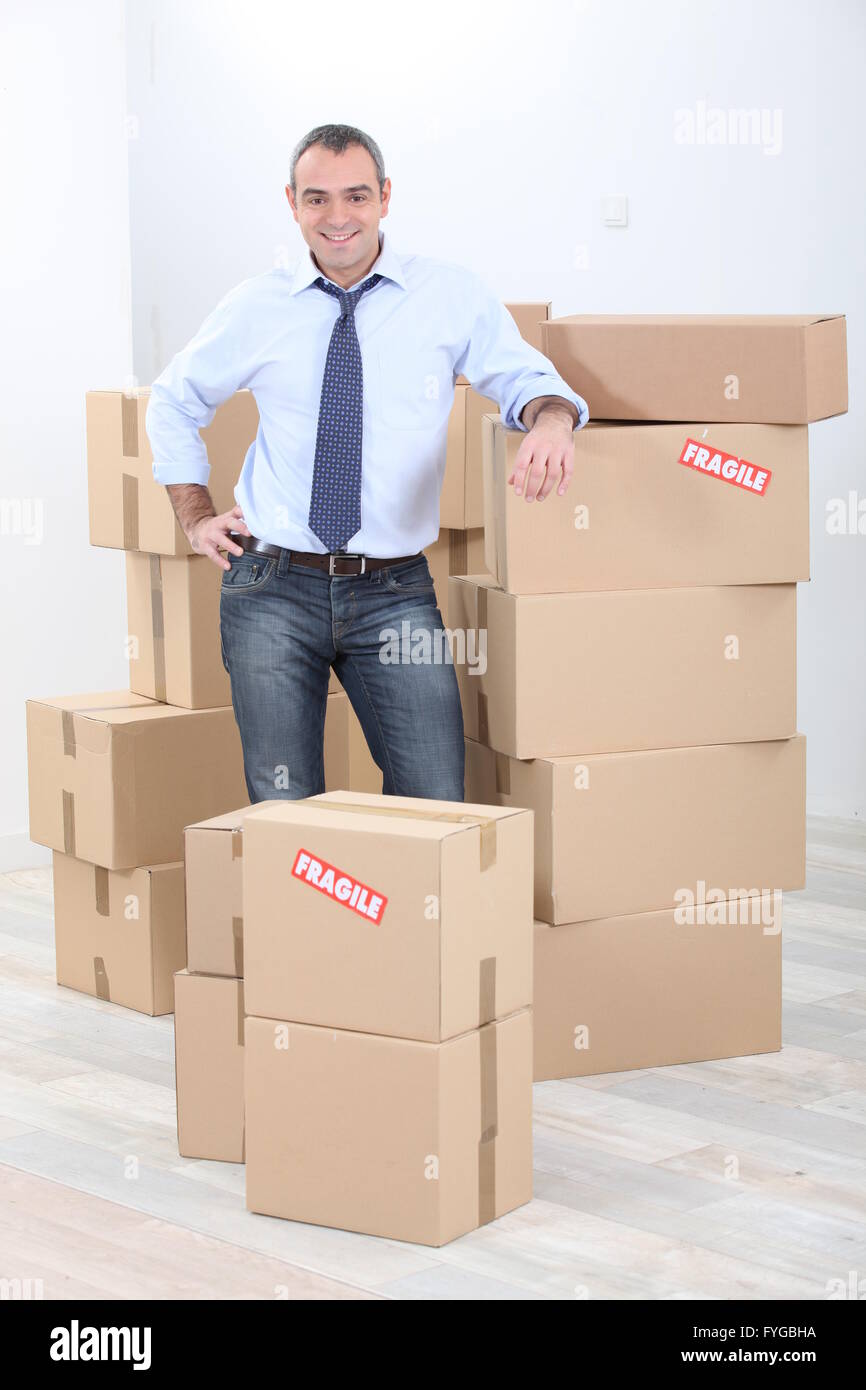 Horizontal image of a man surrounded by cardboard Stock Photo - Alamy