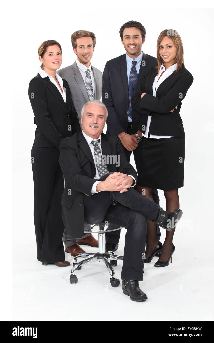 Young business team standing behind their boss Stock Photo - Alamy