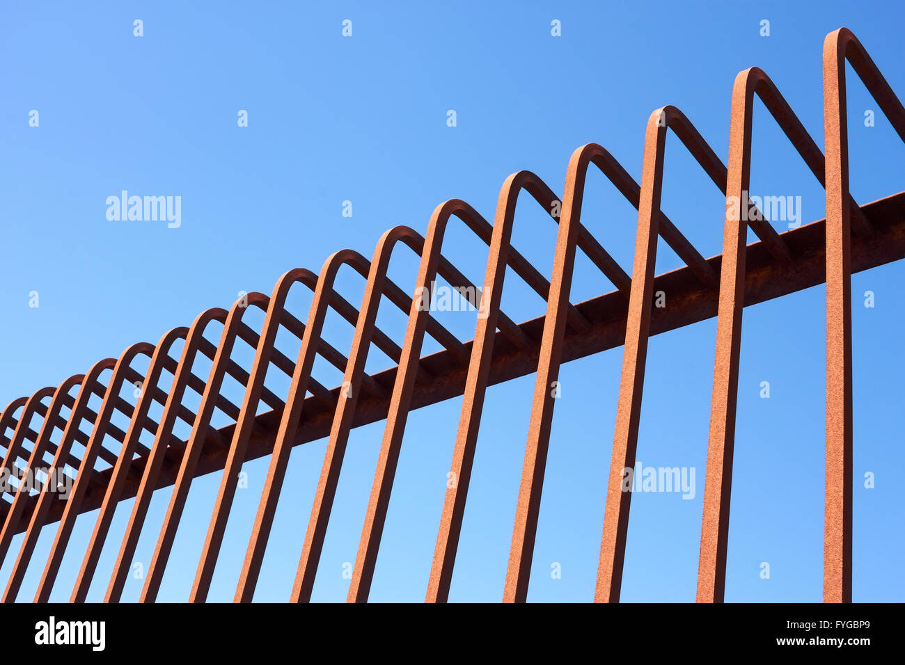 Metal fence with bent rods Stock Photo - Alamy