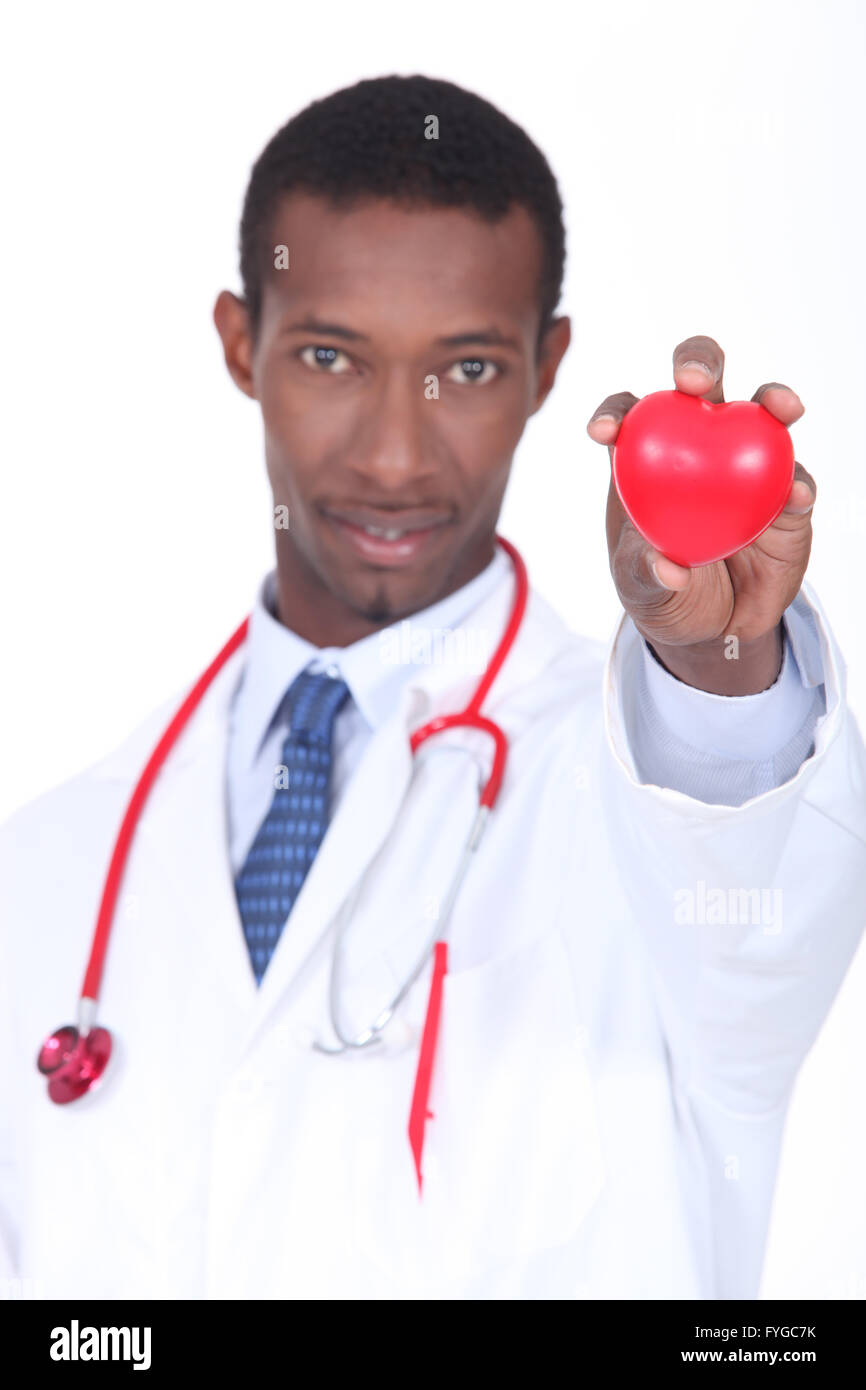 Plastic heart being held by a hospital doctor Stock Photo - Alamy