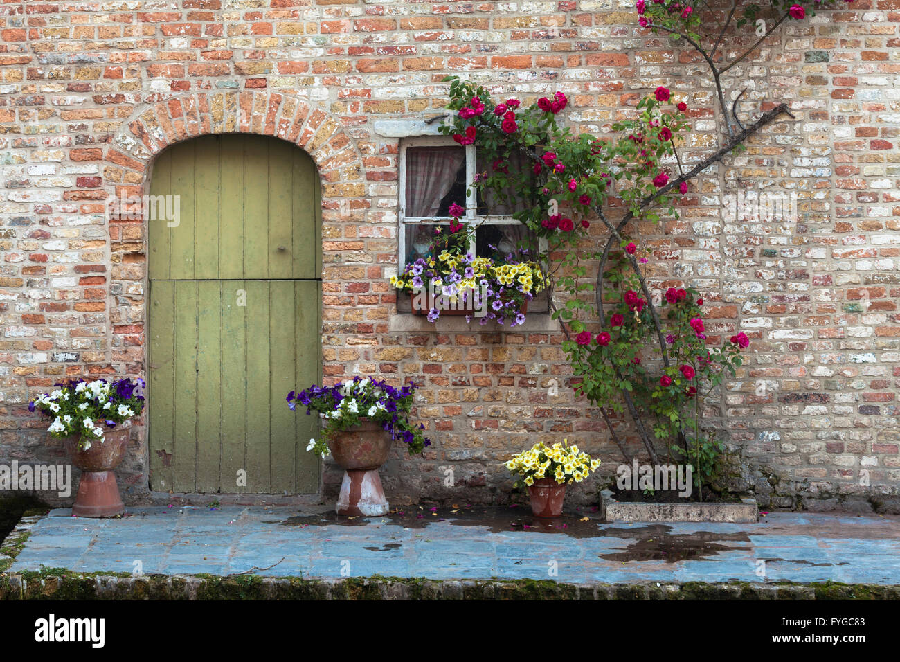 Facade with flowers in spring in a house near one of the canals of ...