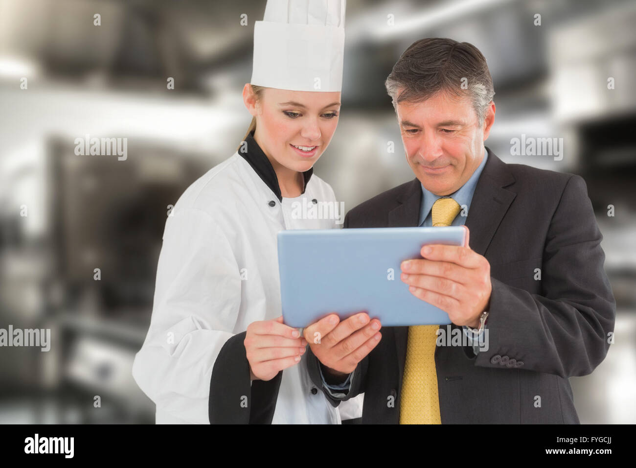 Composite image of businessman and female chef using digital tablet ...