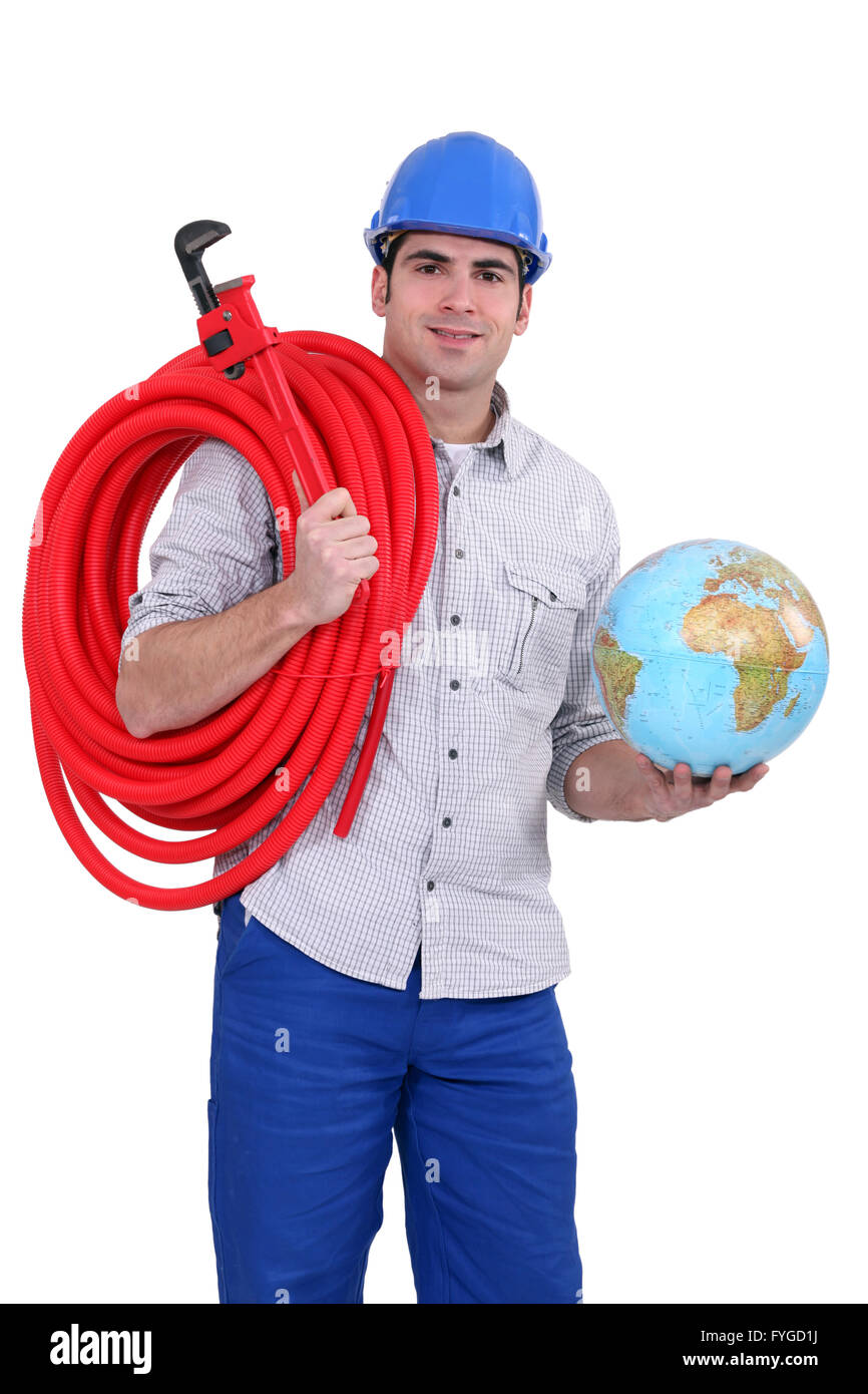 portrait of young plumber holding globe with hose over his shoulder ...