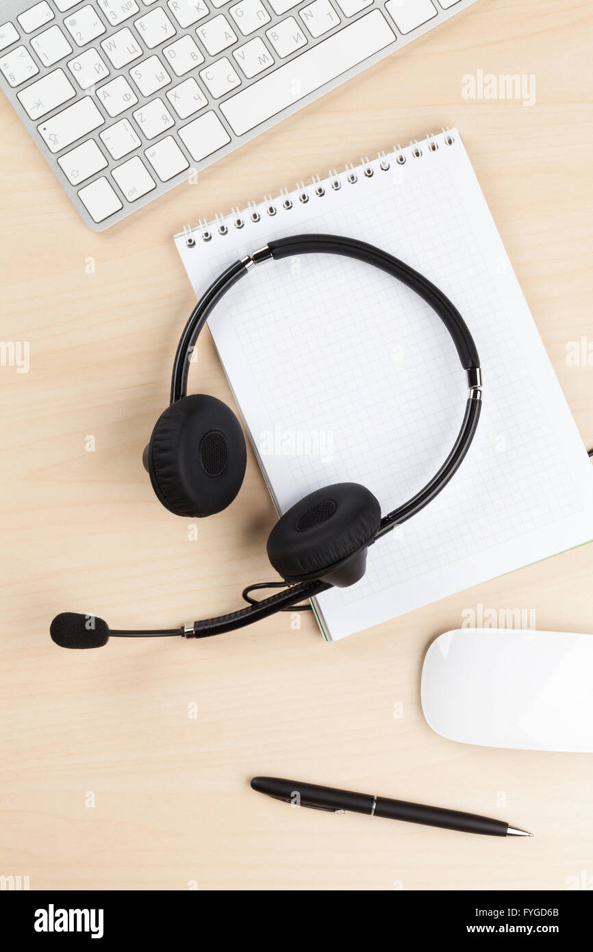 Office desk with headset and pc. Call center support table. Veiw with ...