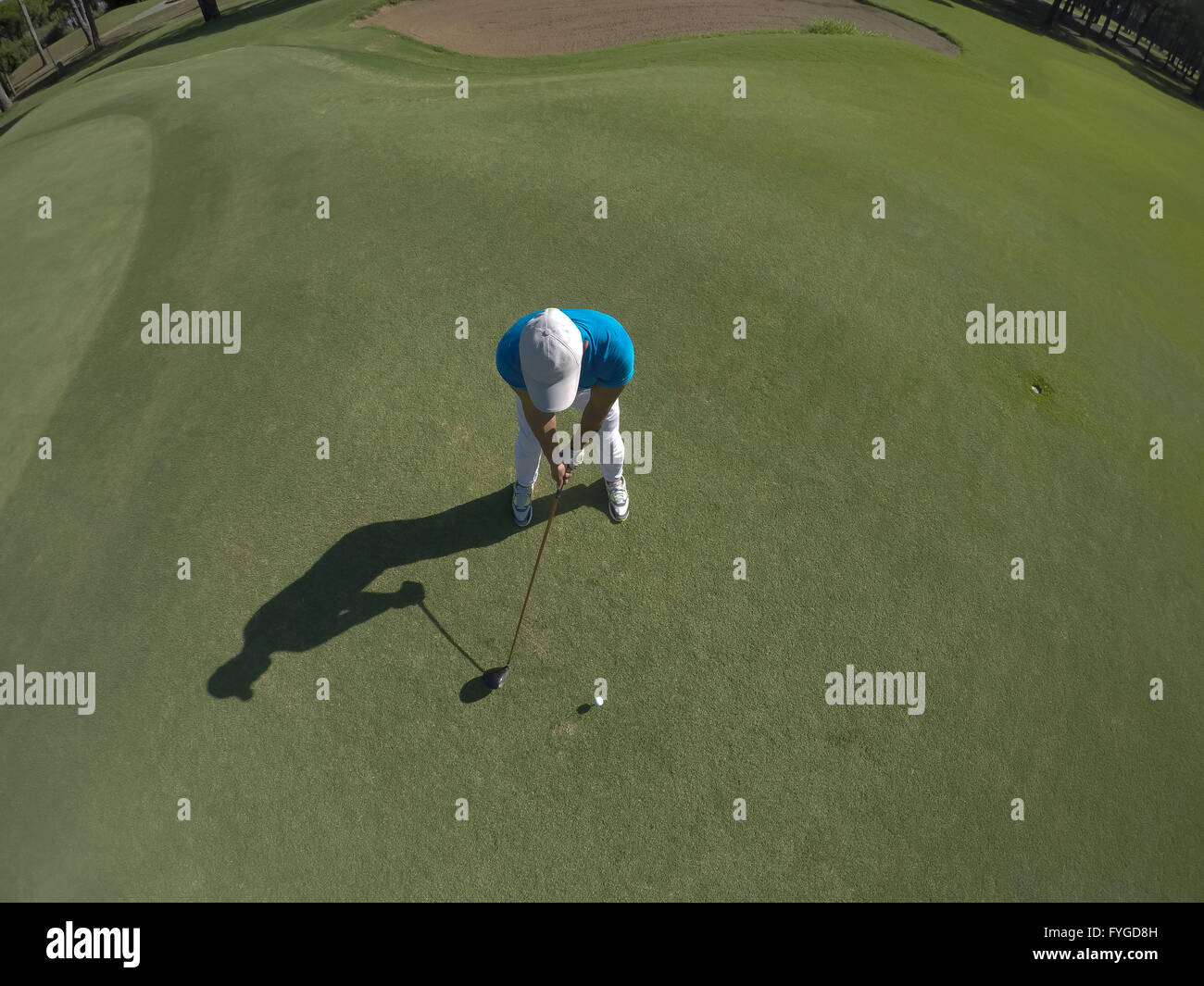 top view of golf player hitting shot with club on course at beautiful ...