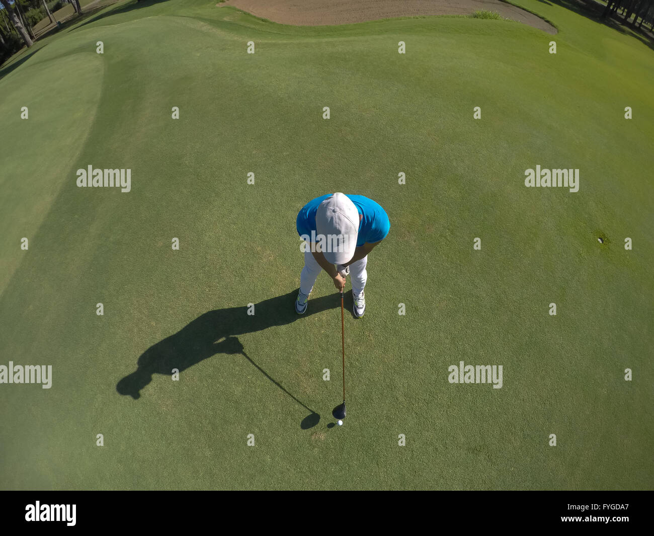 top view of golf player hitting shot with club on course at beautiful ...