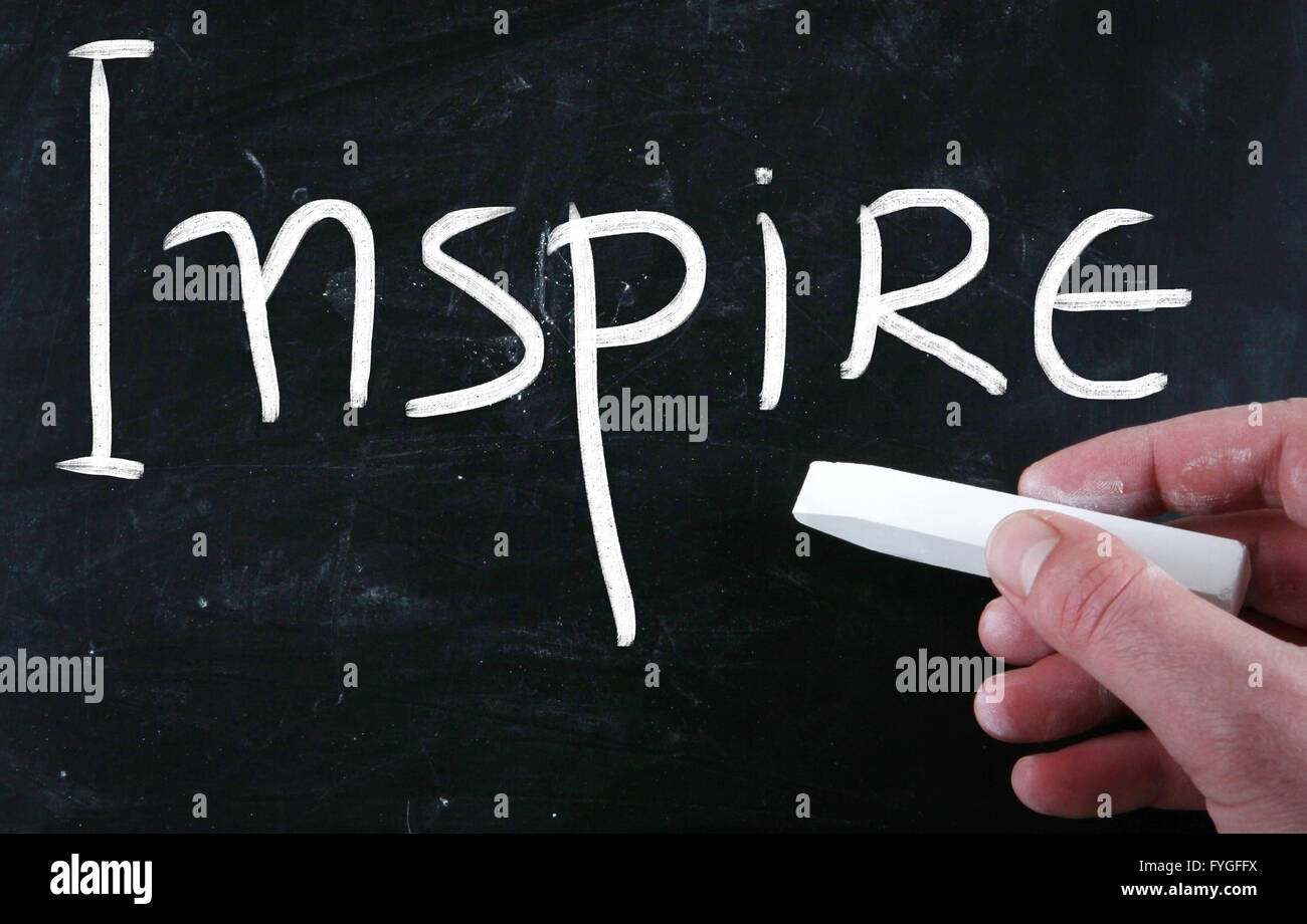 Inspire handwritten with white chalk on a blackboard Stock Photo - Alamy