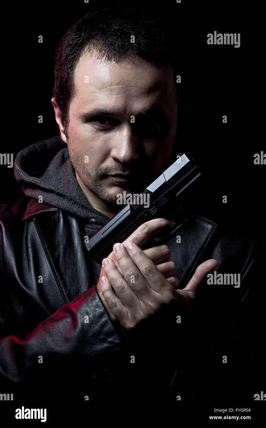ganster, dangerous man with a gun, shooting Stock Photo - Alamy