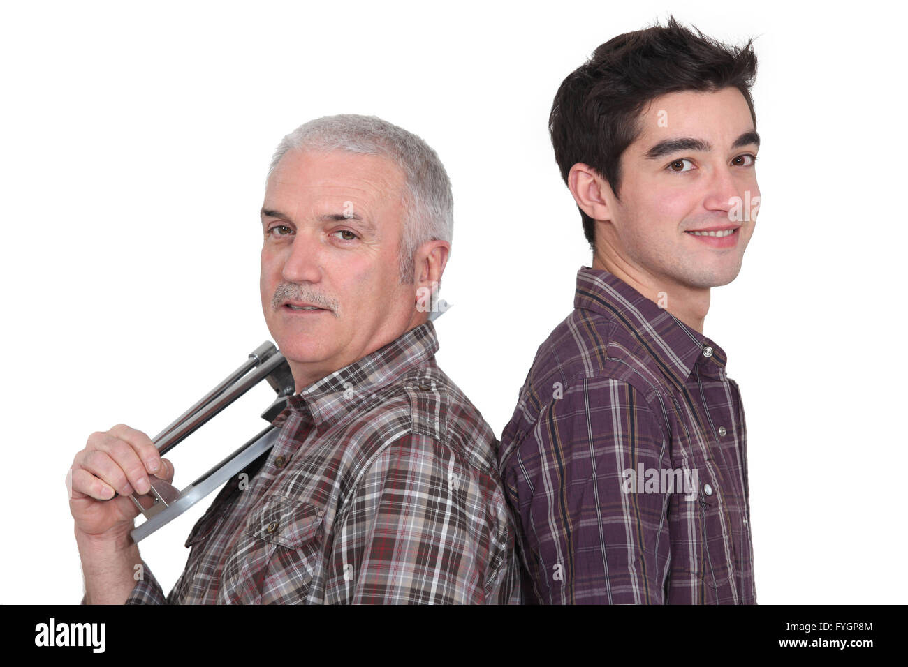 craftsman and apprentice standing back to back Stock Photo - Alamy