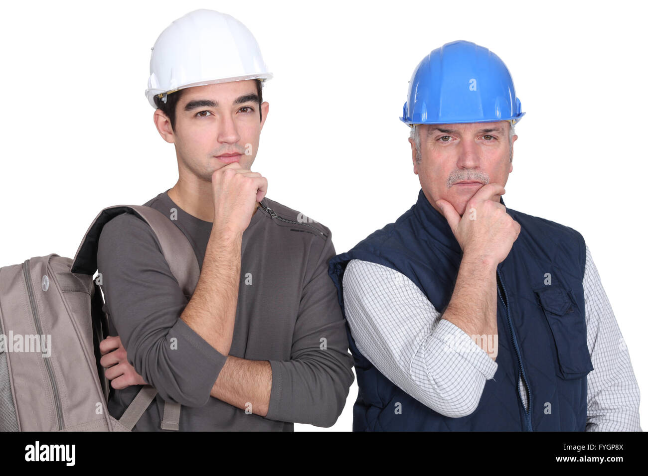young apprentice and older instructor looking puzzled Stock Photo - Alamy
