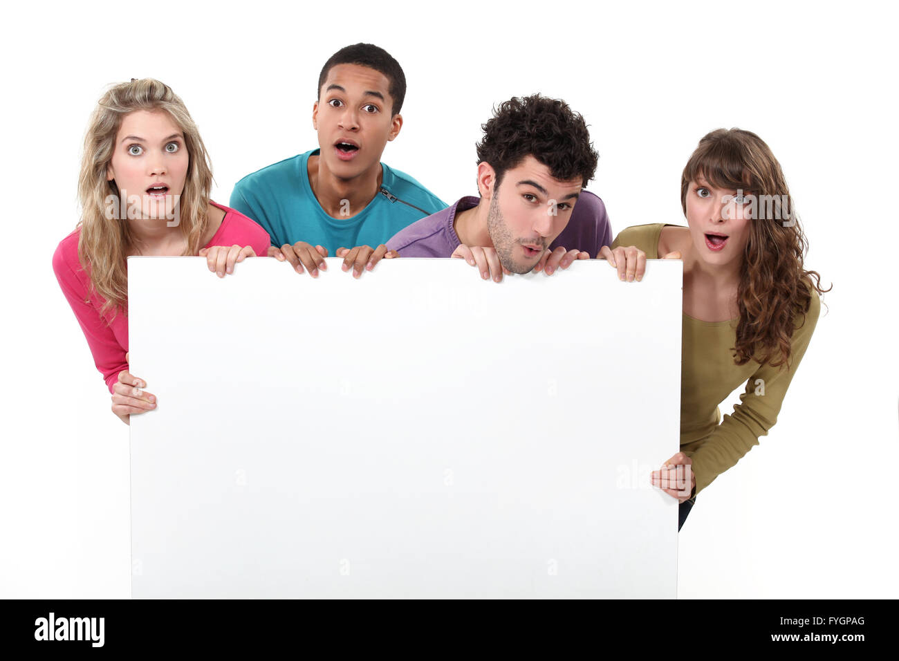 Two young couples stood with advertising board Stock Photo - Alamy