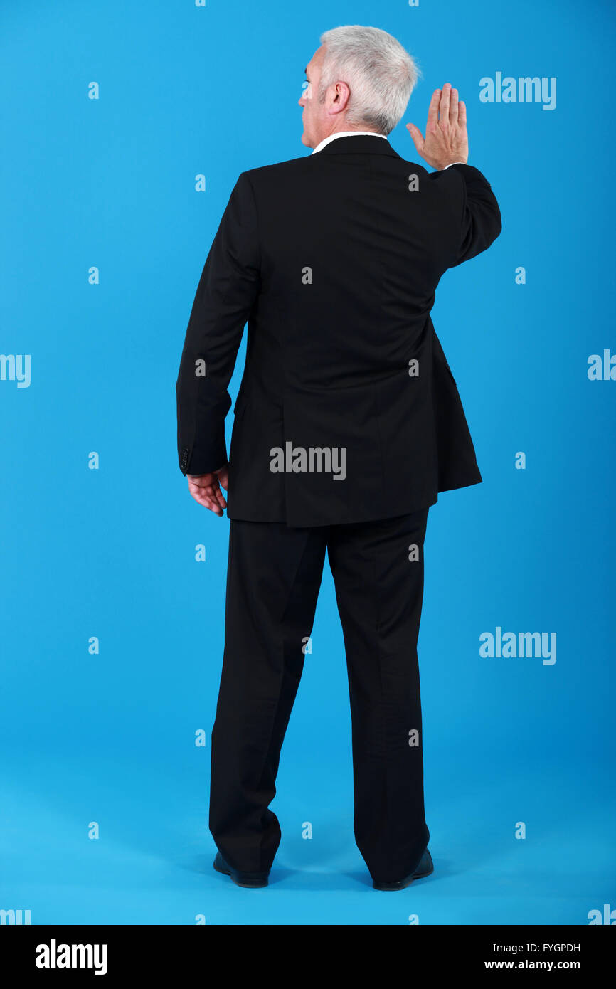 Grey-haired business man with back turned to camera Stock Photo - Alamy