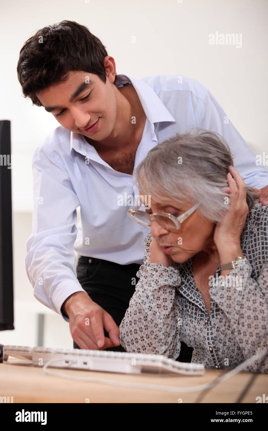 grandson learning his grandmother haw to use a computer Stock Photo - Alamy