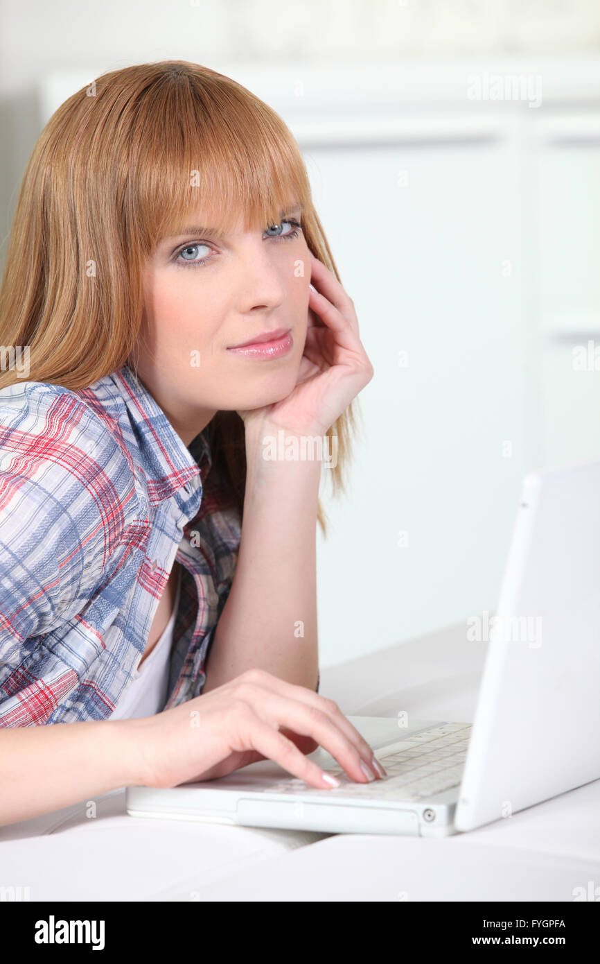 Causal redheaded woman using a white laptop computer Stock Photo - Alamy