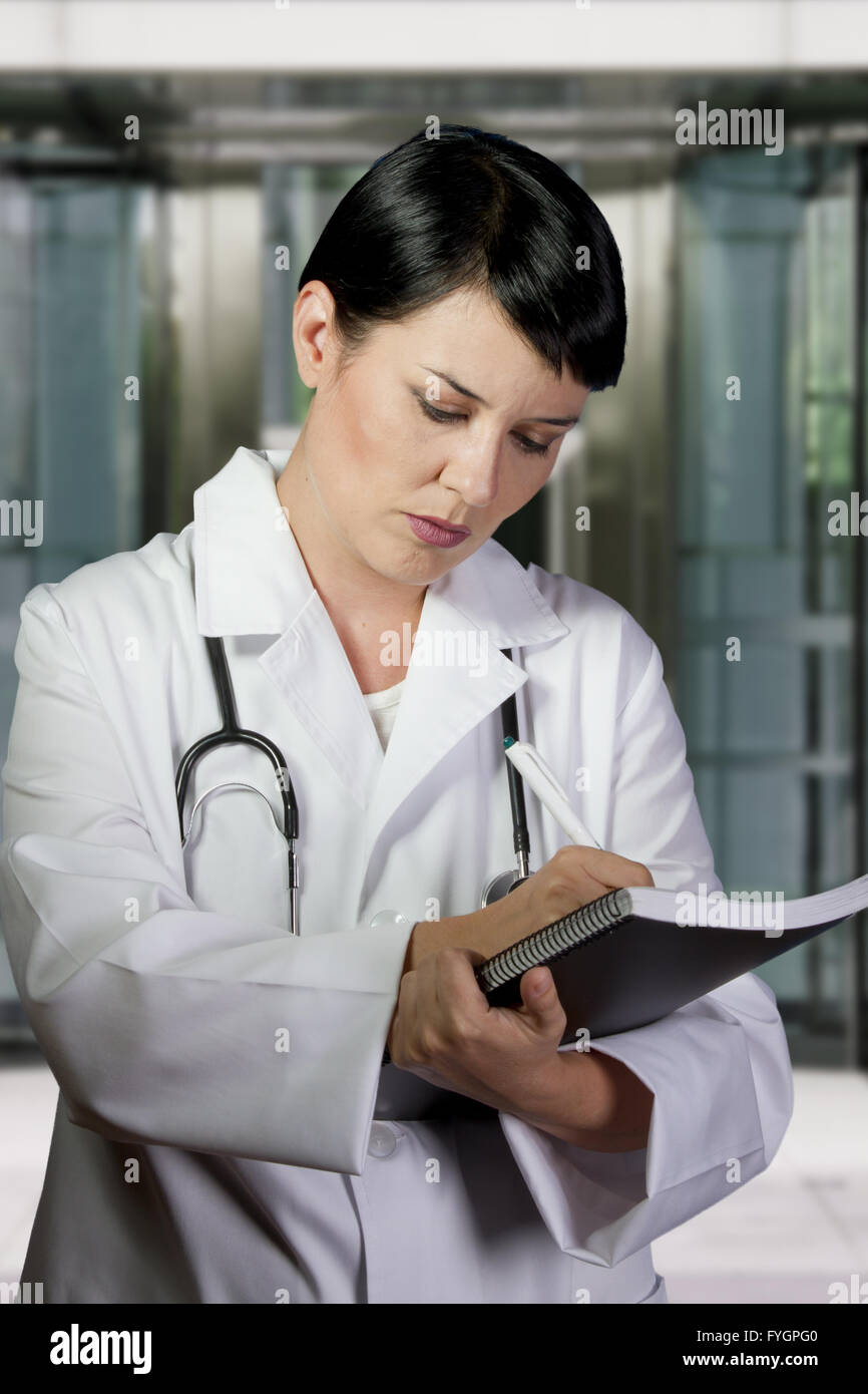 Thinking medical doctor with stethoscope. Over hospital background ...