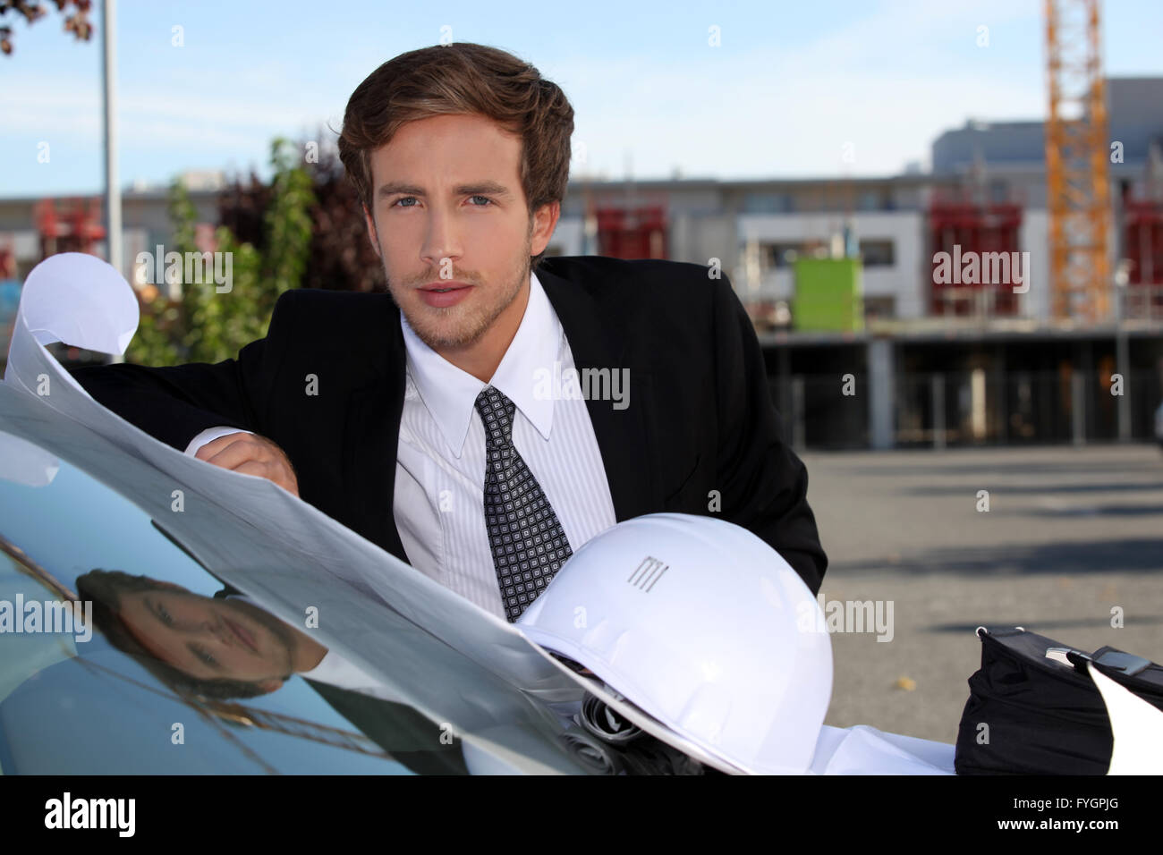 An engineer looking at a blueprint before a meeting Stock Photo - Alamy