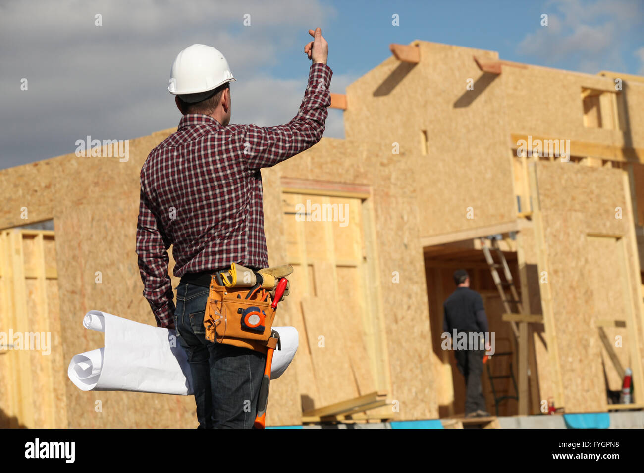 Tradesman standing in front of an unfinished house Stock Photo - Alamy