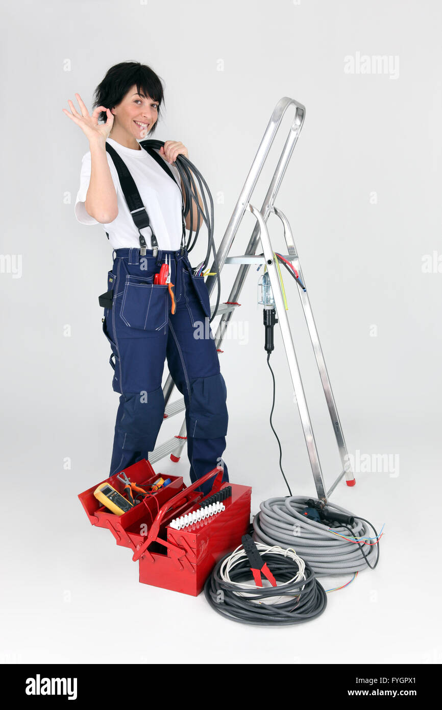 Tradeswoman posing with her tools and building supplies Stock Photo - Alamy