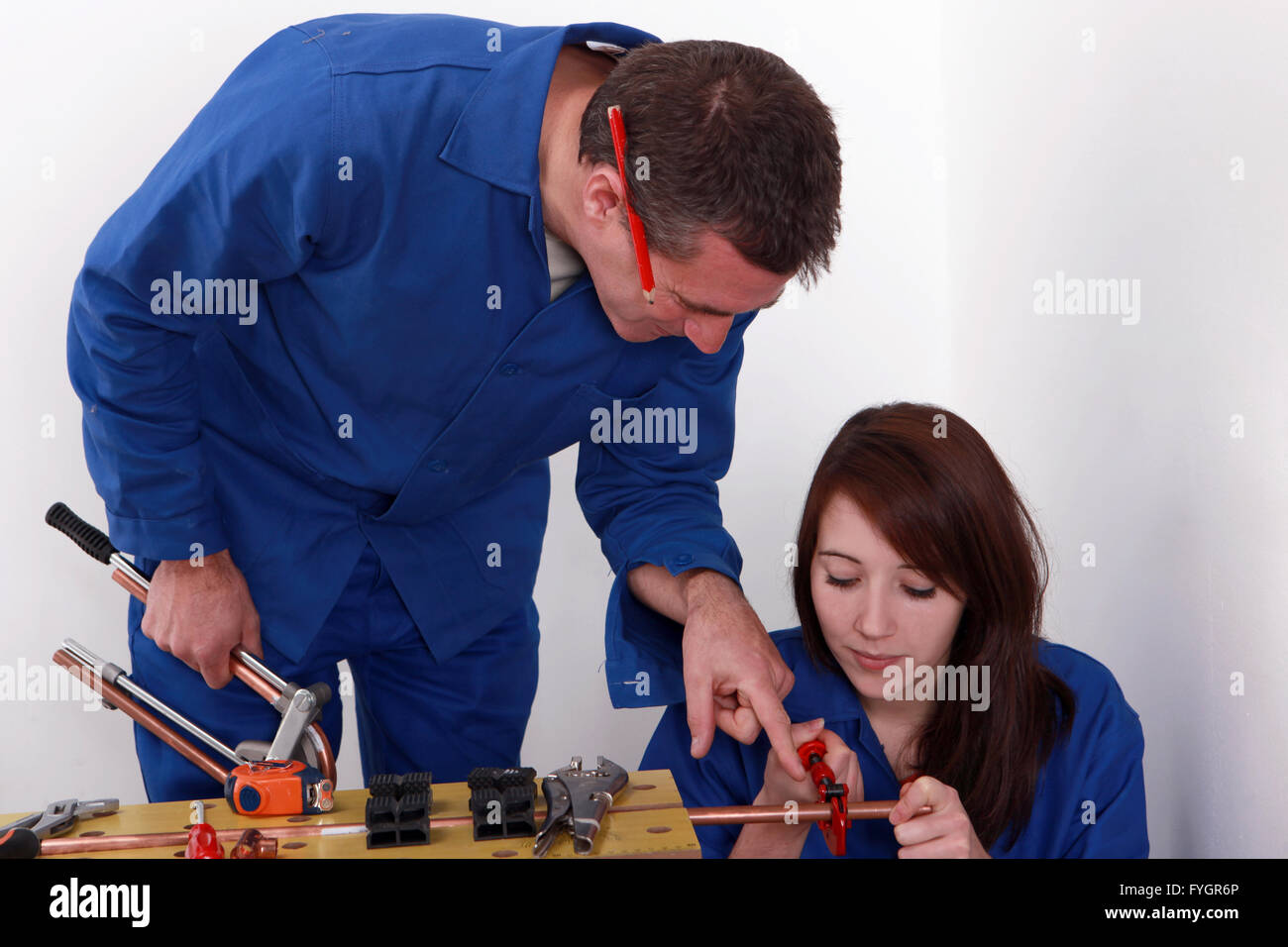 craftsman giving explanations to his apprentice Stock Photo - Alamy
