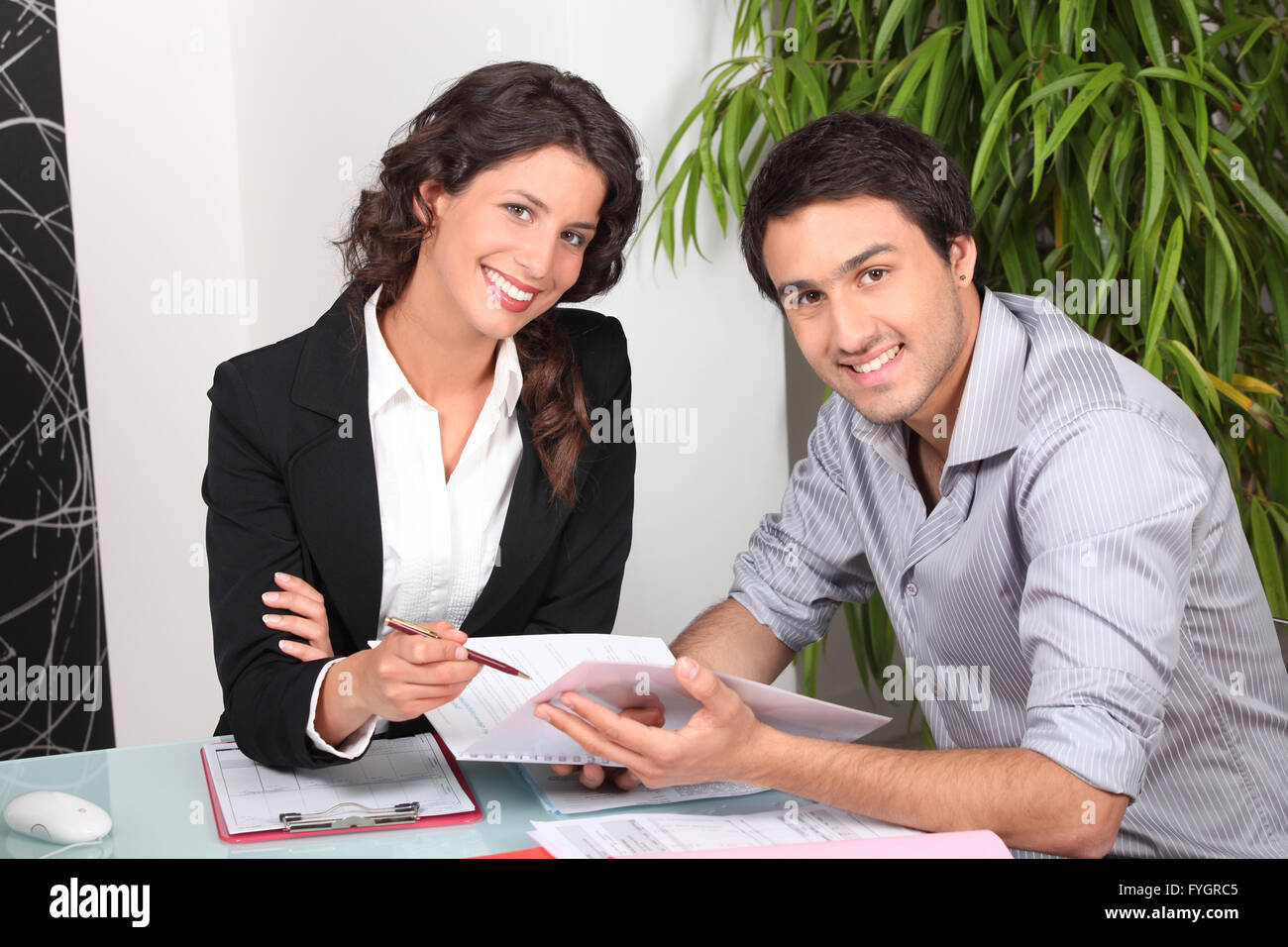 Businesswoman discussing a contract with her client Stock Photo - Alamy