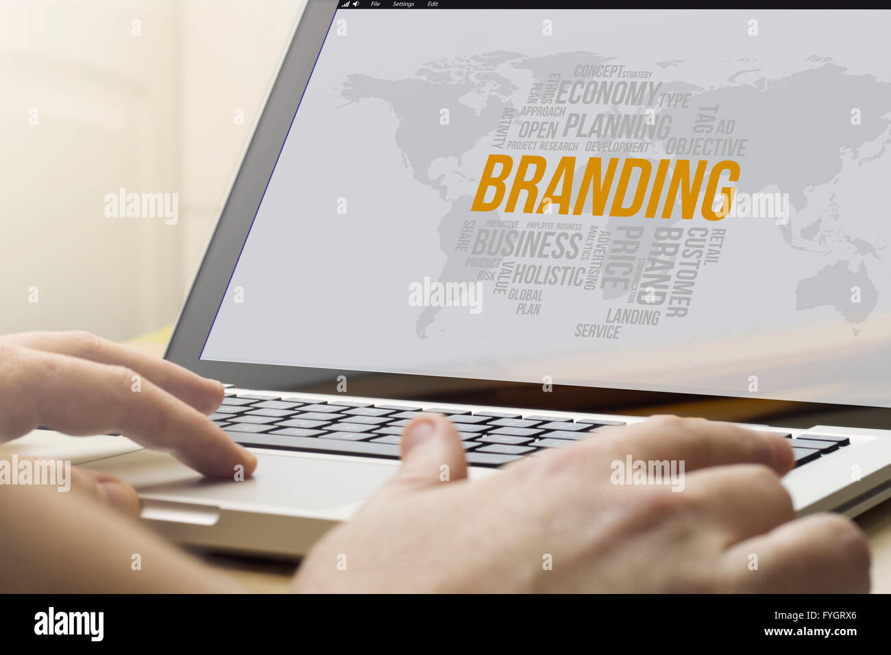 branding concept: man using a laptop with branding on the screen ...