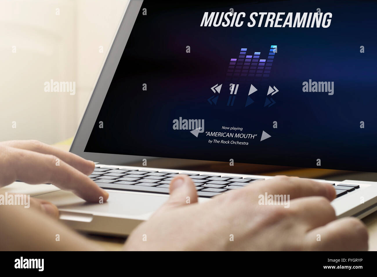 online streaming music concept: man using a laptop with music streaming ...