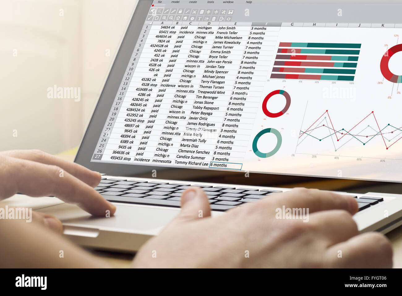 finances concept: man using a laptop with spreadsheet on the screen ...