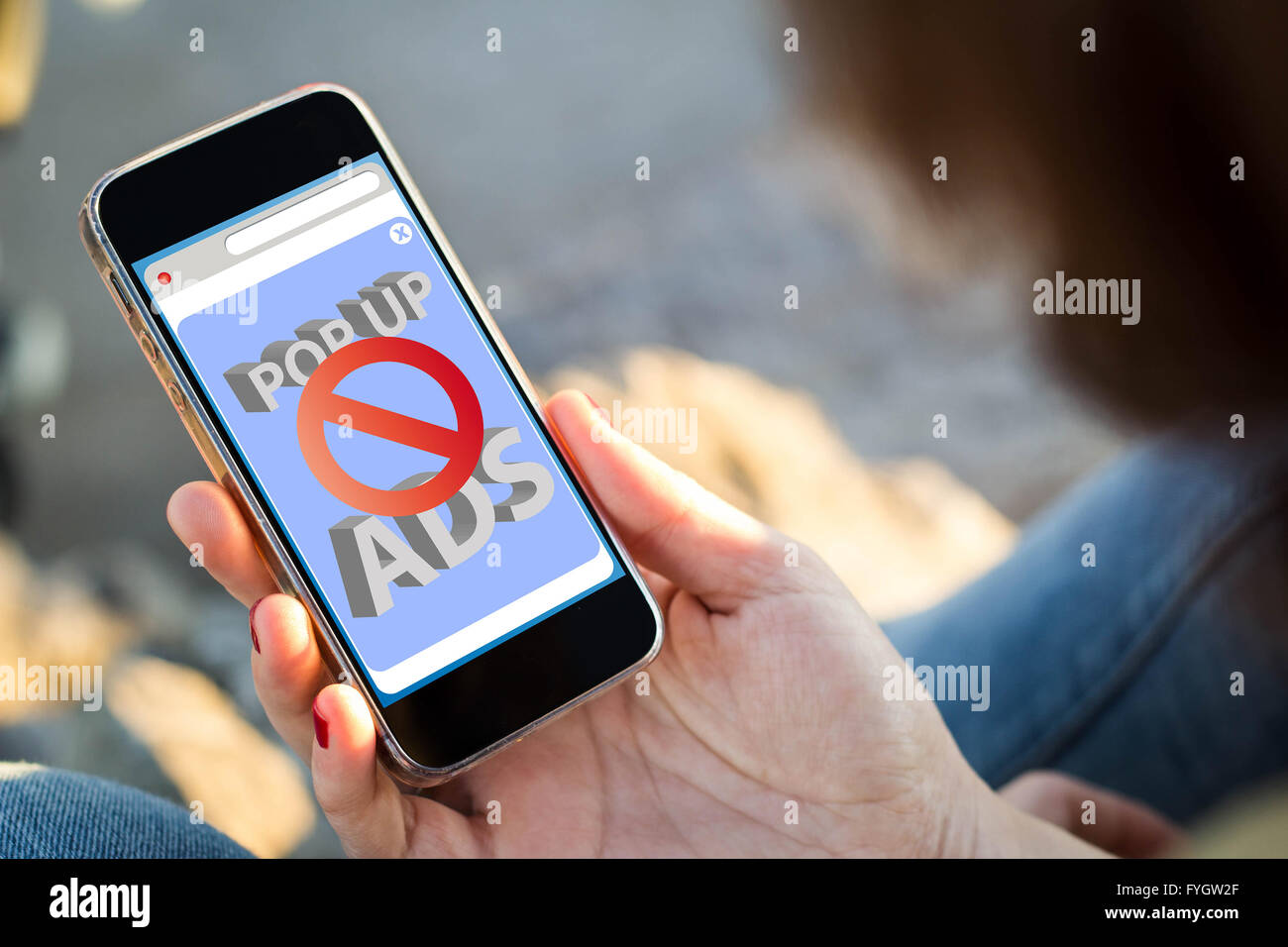 close-up view of young woman checking her mobile phone with ads blocked ...