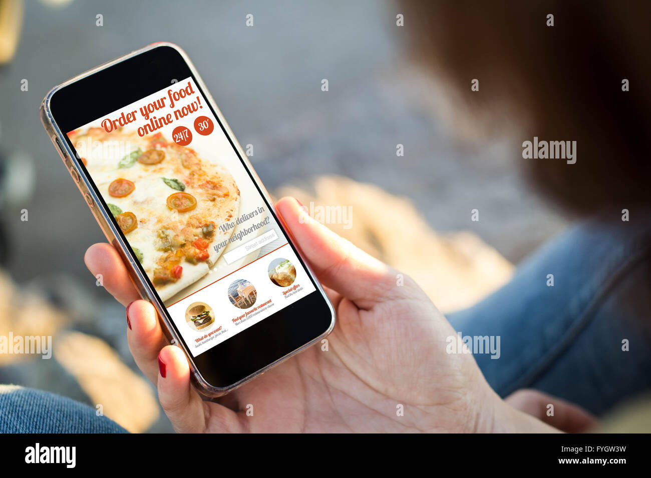 close-up view of young woman checking her mobile phone to order online ...