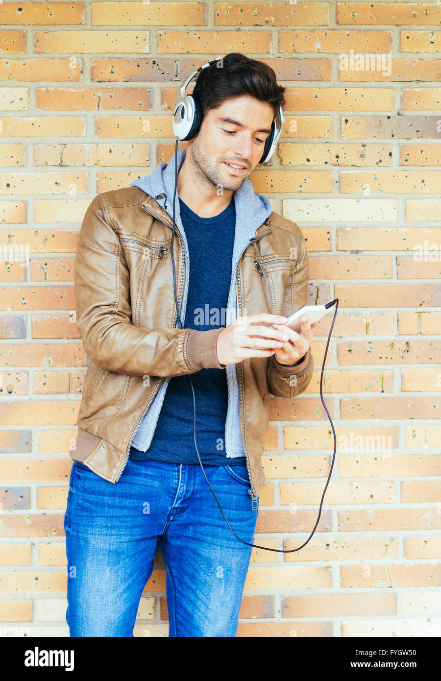handsome man in headphones listening to music with smartphone Stock ...