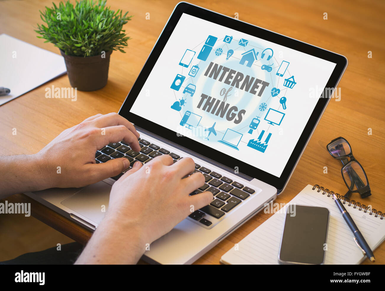 Internet of things concept at a laptop on a desk workplace. All screen ...