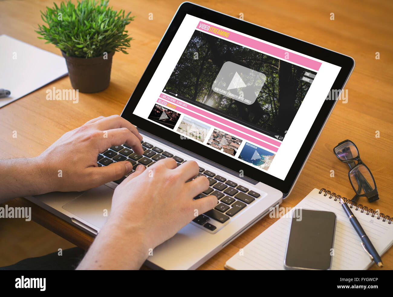 streaming concept. Close-up top view of a man watching videos on laptop ...