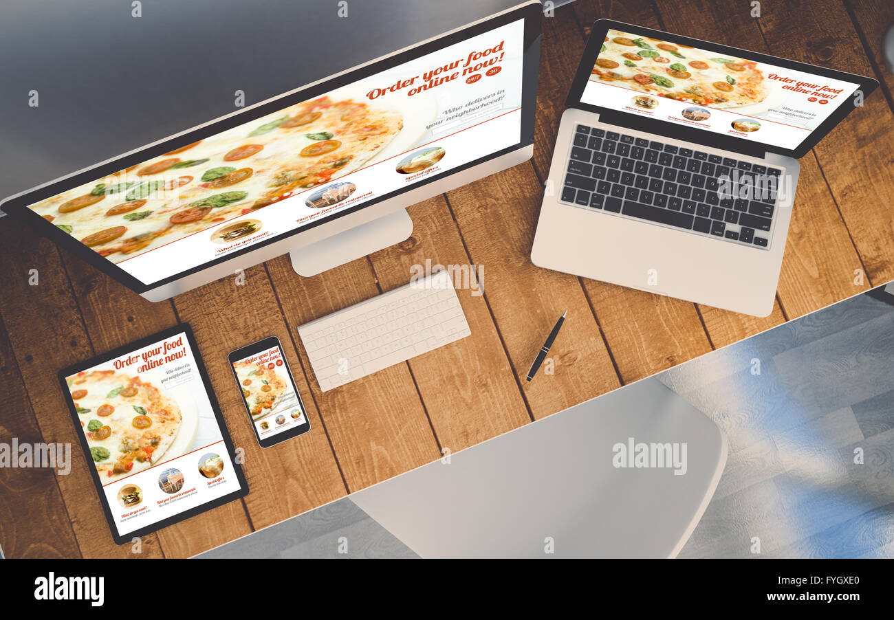 top view of a computer, laptop, smartphone and tablet on a desktop ...