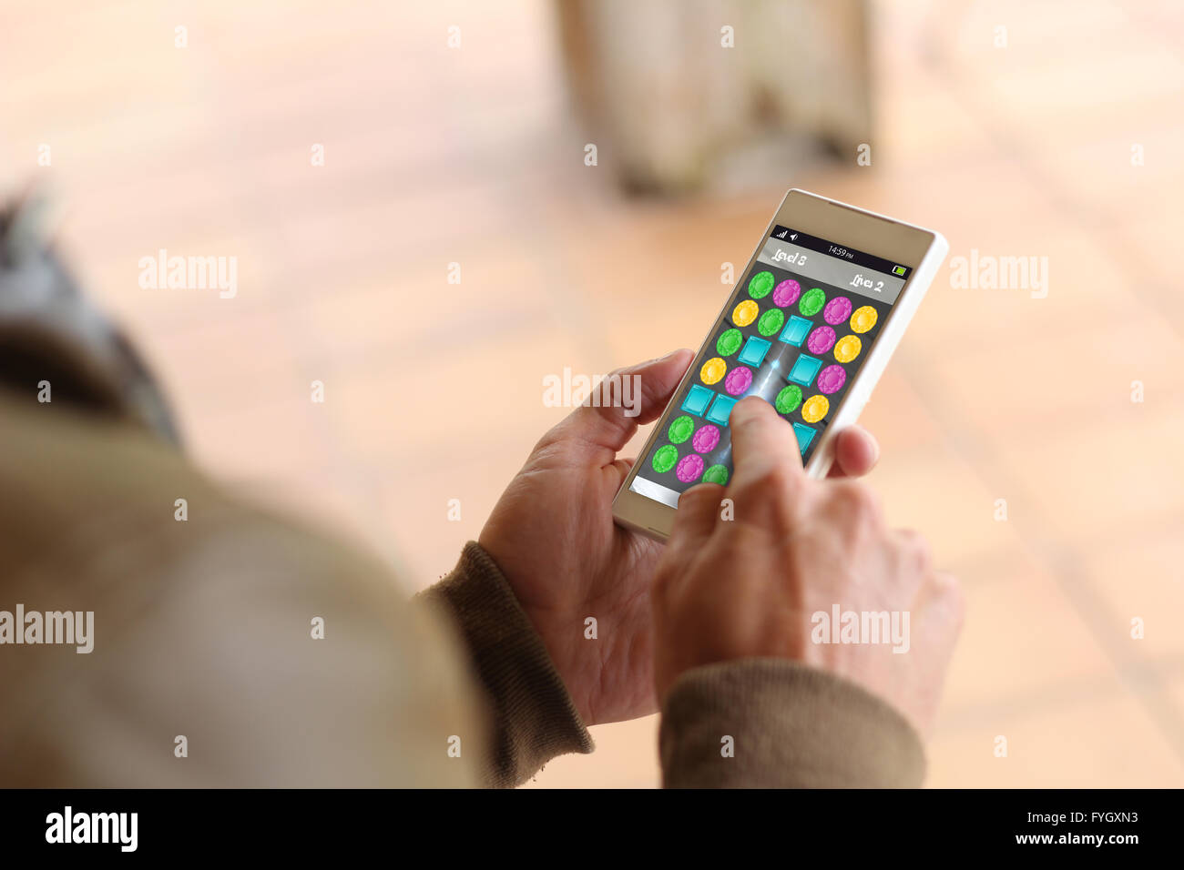 man touching the screen of his smartphone at street to play mobile game ...