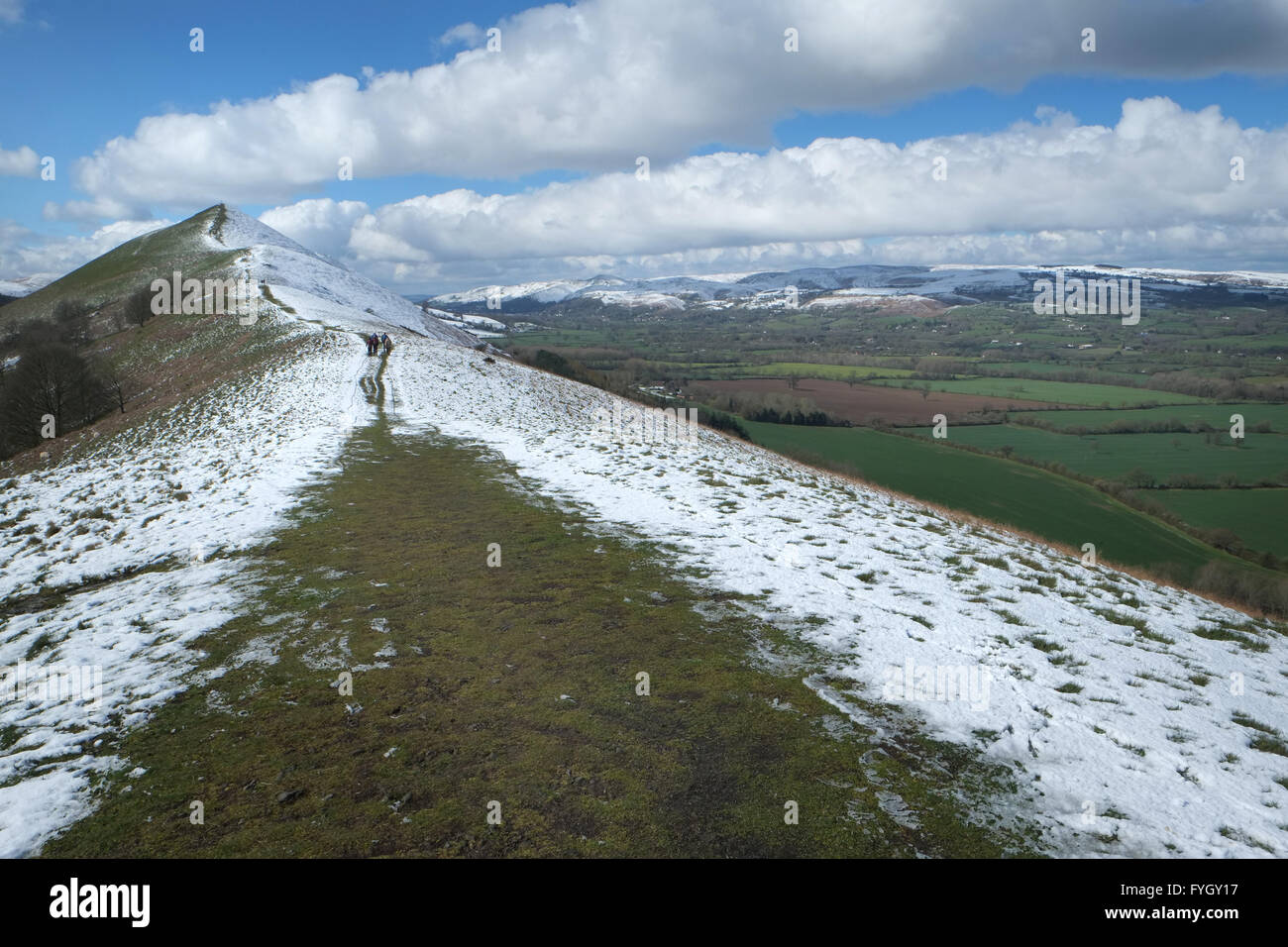 Walkers head towards to peak of The Lawley in Shropshire. The ...