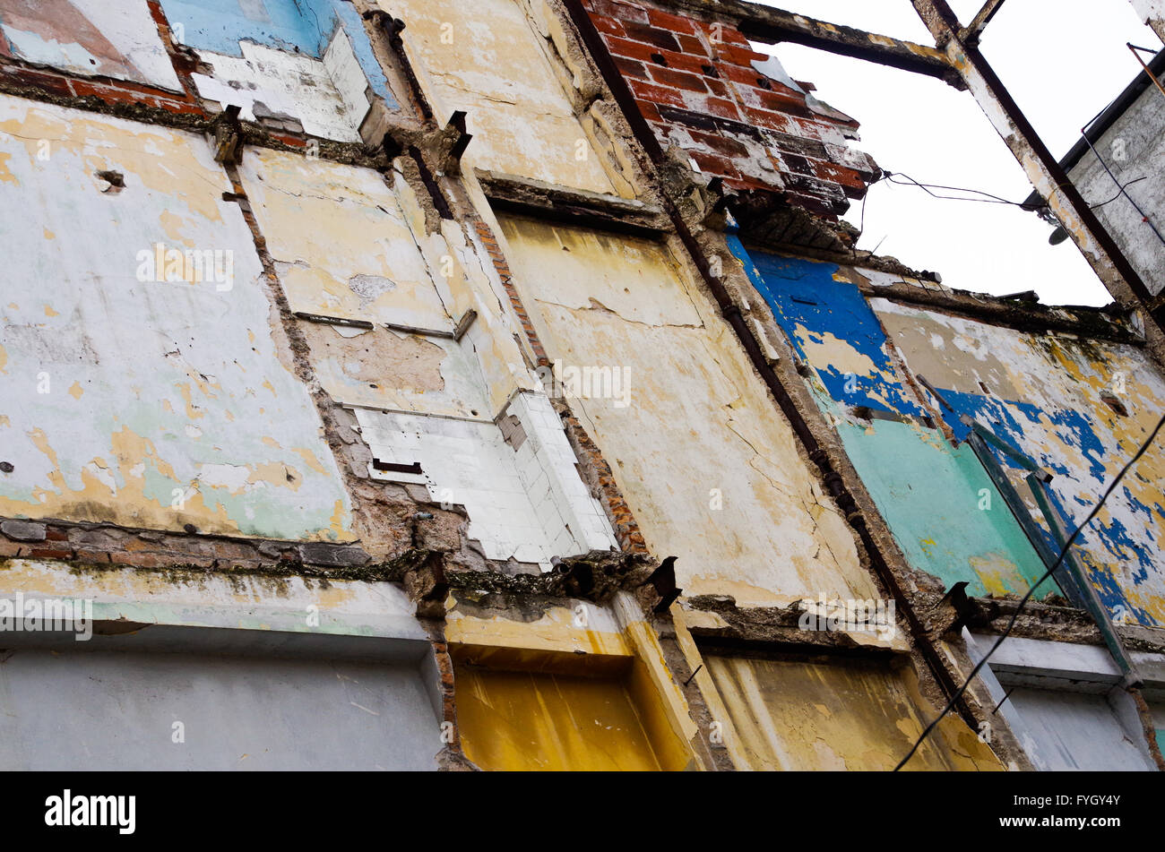 abandoned building wall with colorful patches where there used to be ...