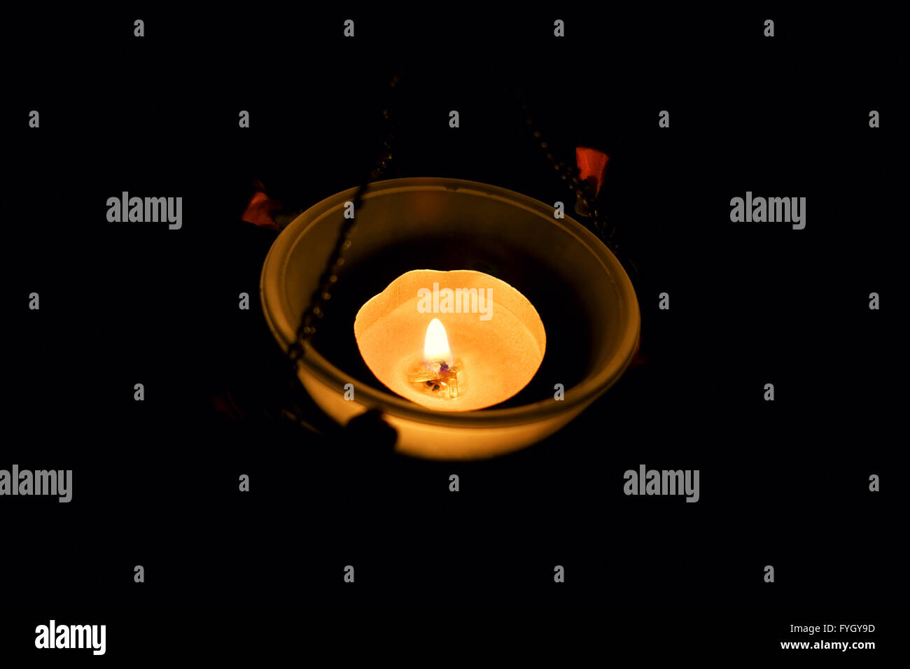 Small fire candle in a candlestick Stock Photo - Alamy