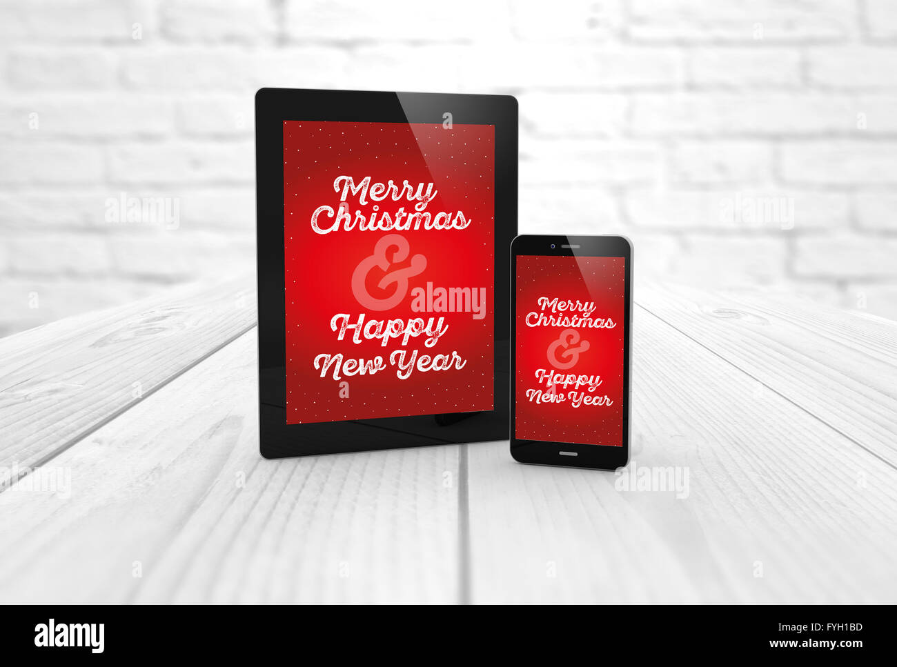 digital generated tablet and smartphone with Christmas greeting on ...