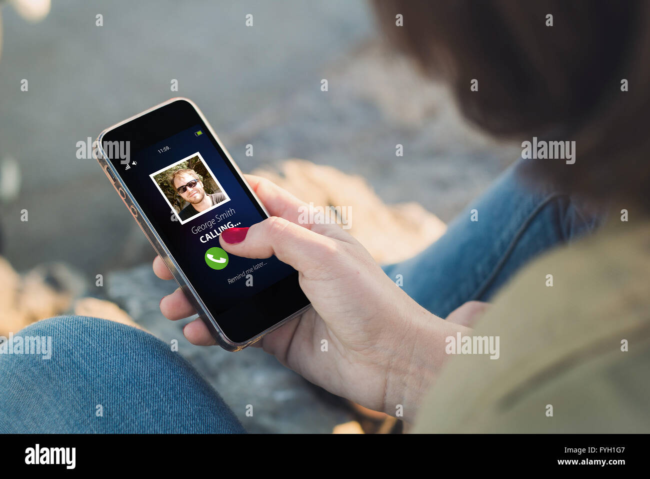 woman holding a smartphone with incoming call on screen. All screen ...