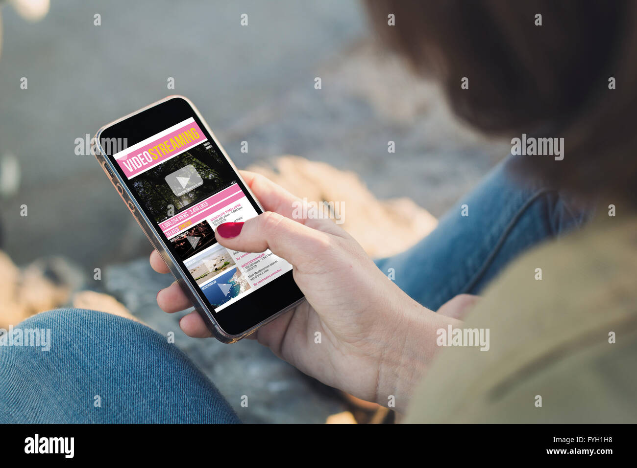 woman holding a smartphone to play videos and touching the screen. All ...