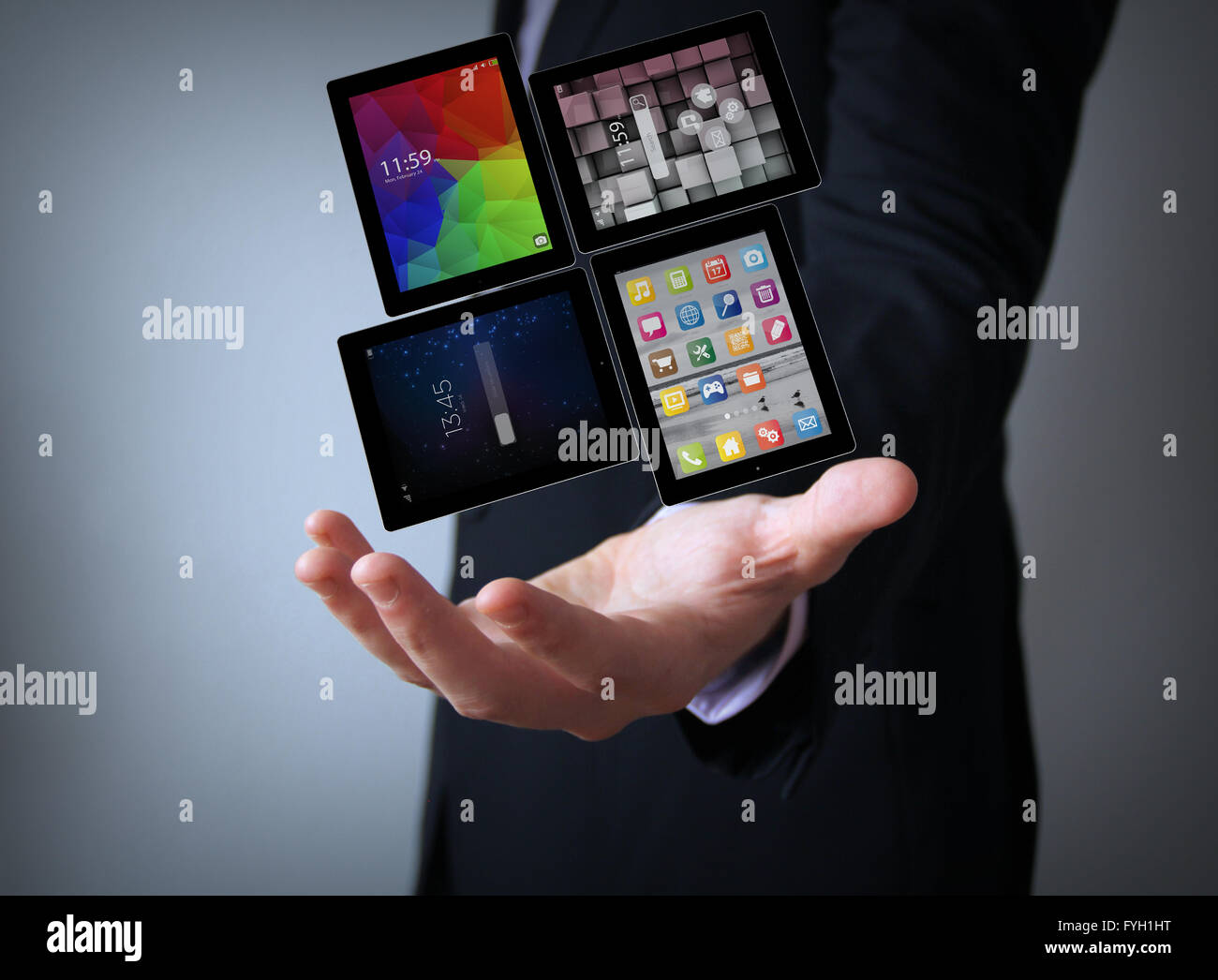 tablets over businessman hand Stock Photo - Alamy