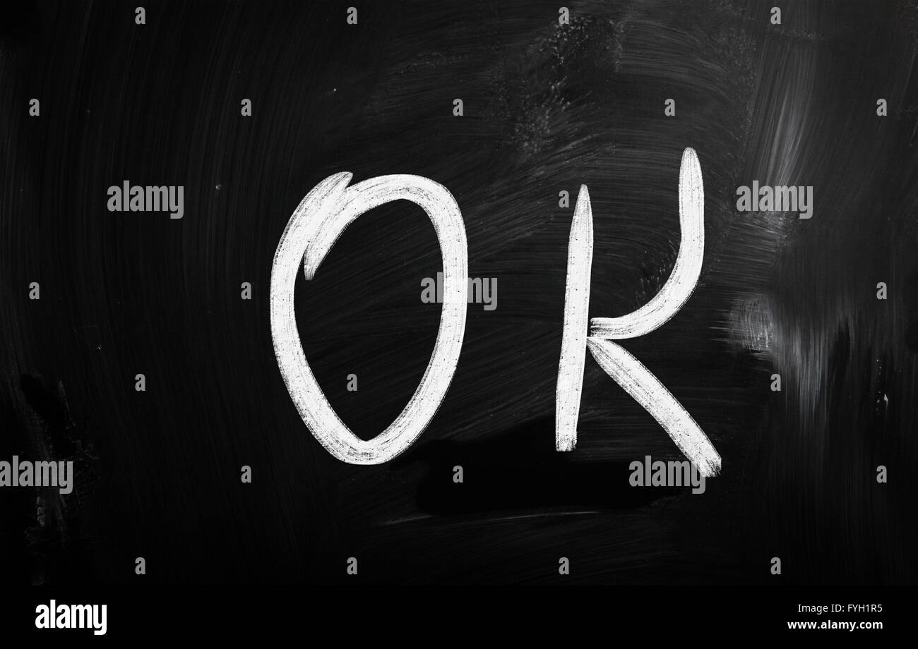 OK handwritten with white chalk on a blackboard Stock Photo - Alamy