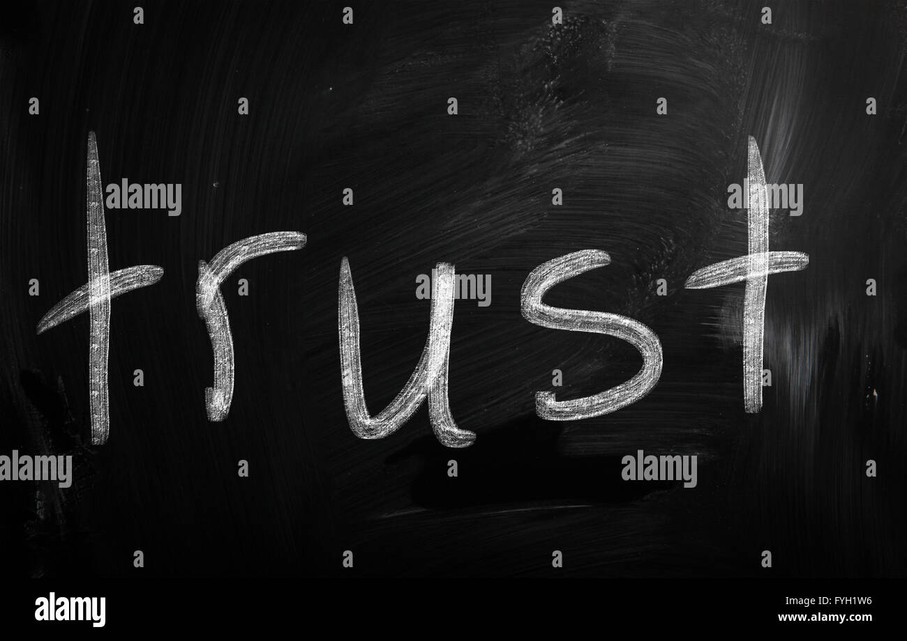 The word Trust handwritten with white chalk on a blackboard Stock Photo ...